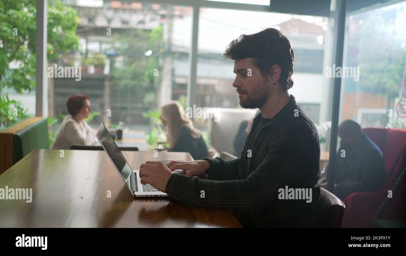 Young entrepreneur or worker opening laptop computer working remotely ...