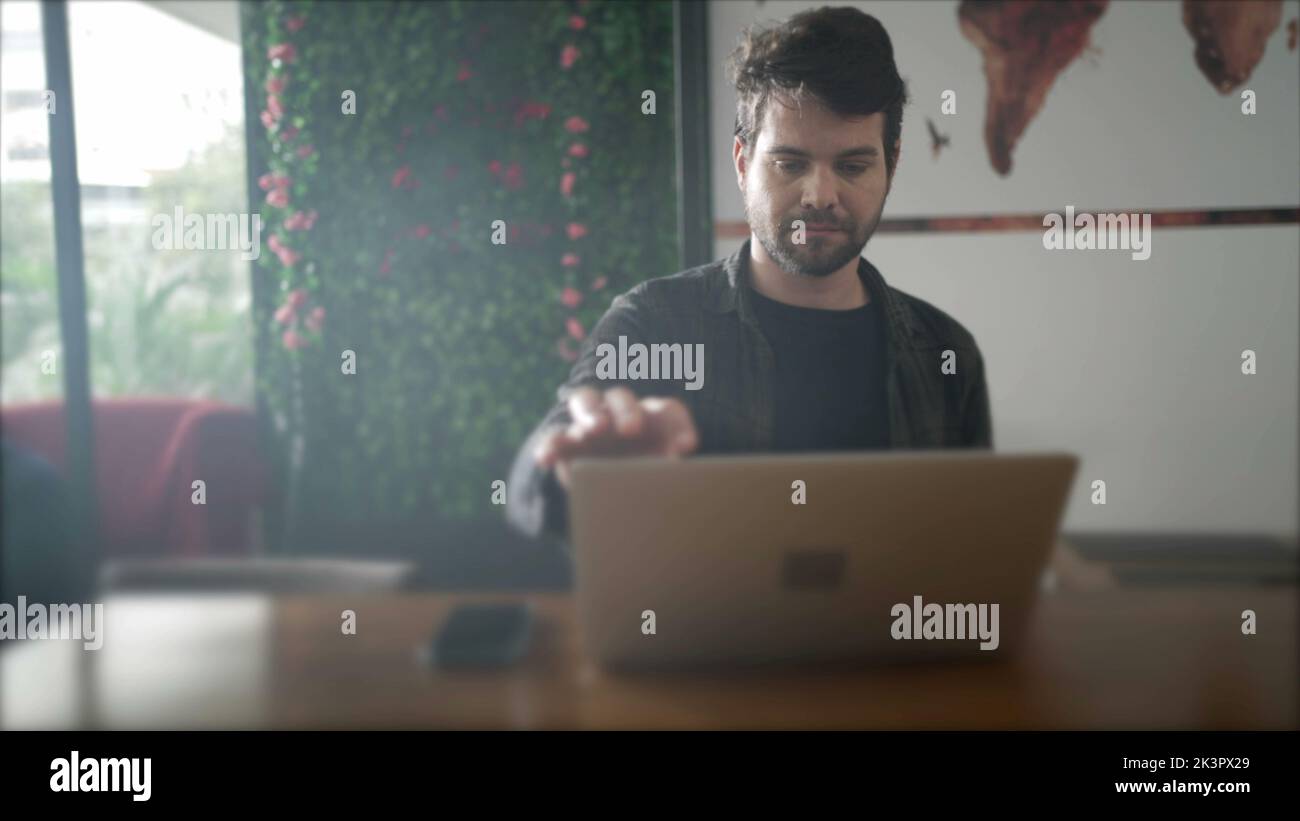 Young entrepreneur opening laptop at coffee shop. person working ...