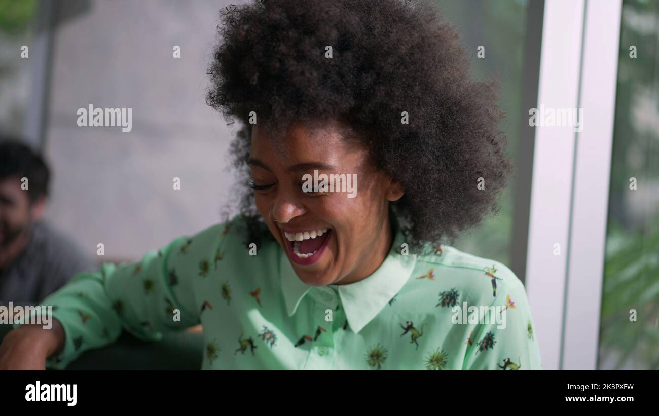 One young black woman laughing and smiling. Portrait of a happy African ...