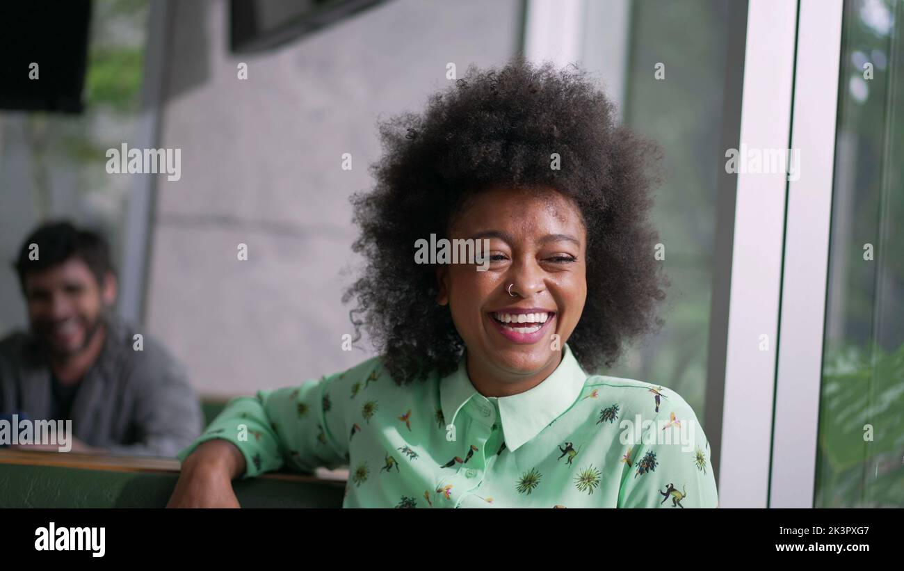One young black woman laughing and smiling. Portrait of a happy African ...