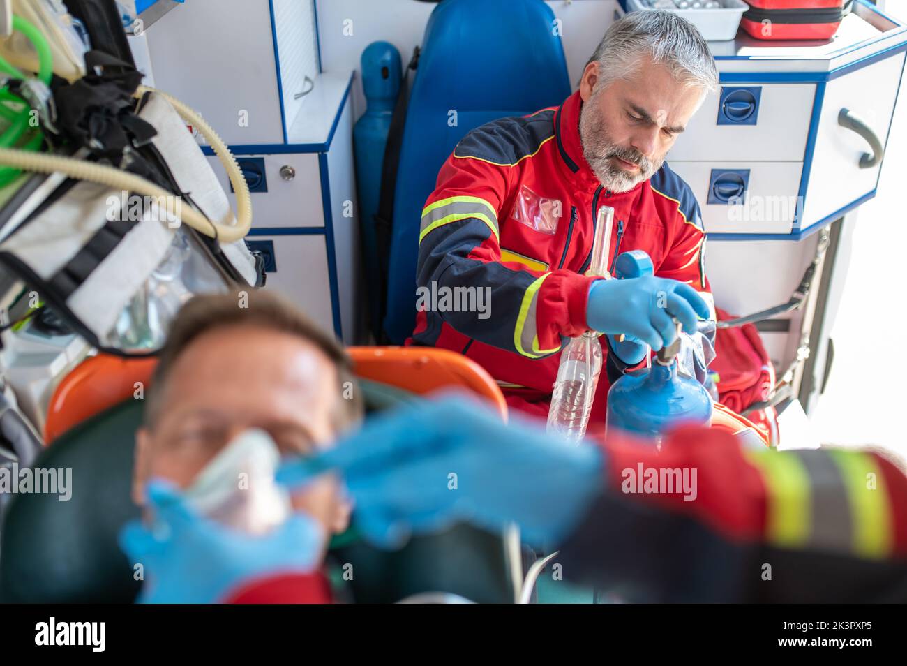 Paramedical staff oxygenating the patient in the ambulance car Stock ...