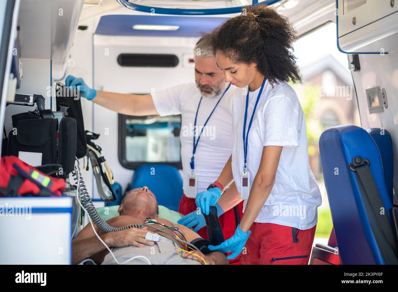 Team of paramedics checking the patient vital signs Stock Photo - Alamy