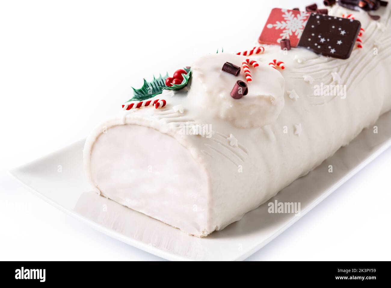 White chocolate yule log cake with ornament isolated on white ...