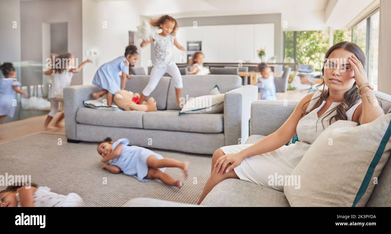Stress, headache and children running, with mother in living room ...