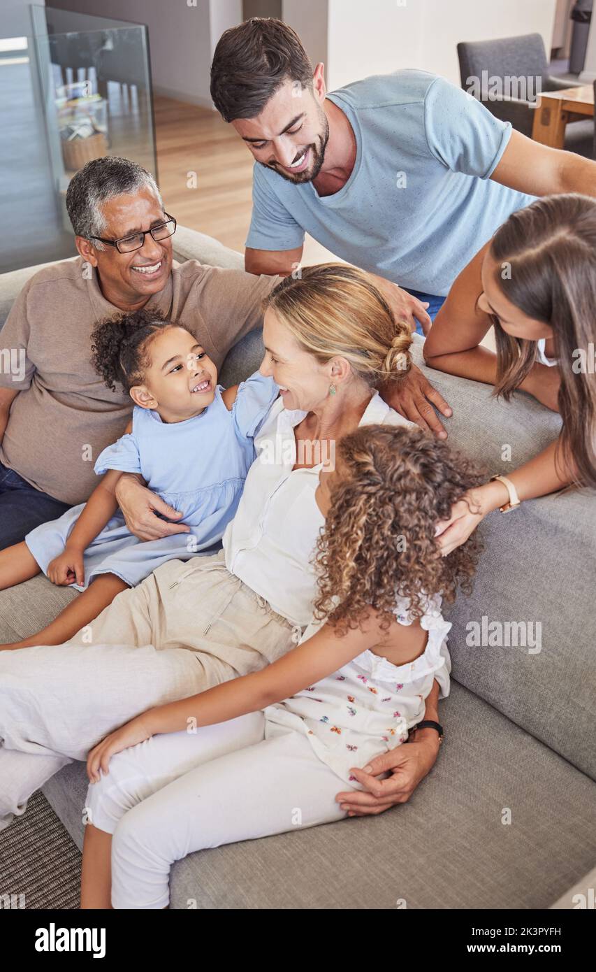 Happy interracial family bonding with their children and grandparents at home. Adults and their ...