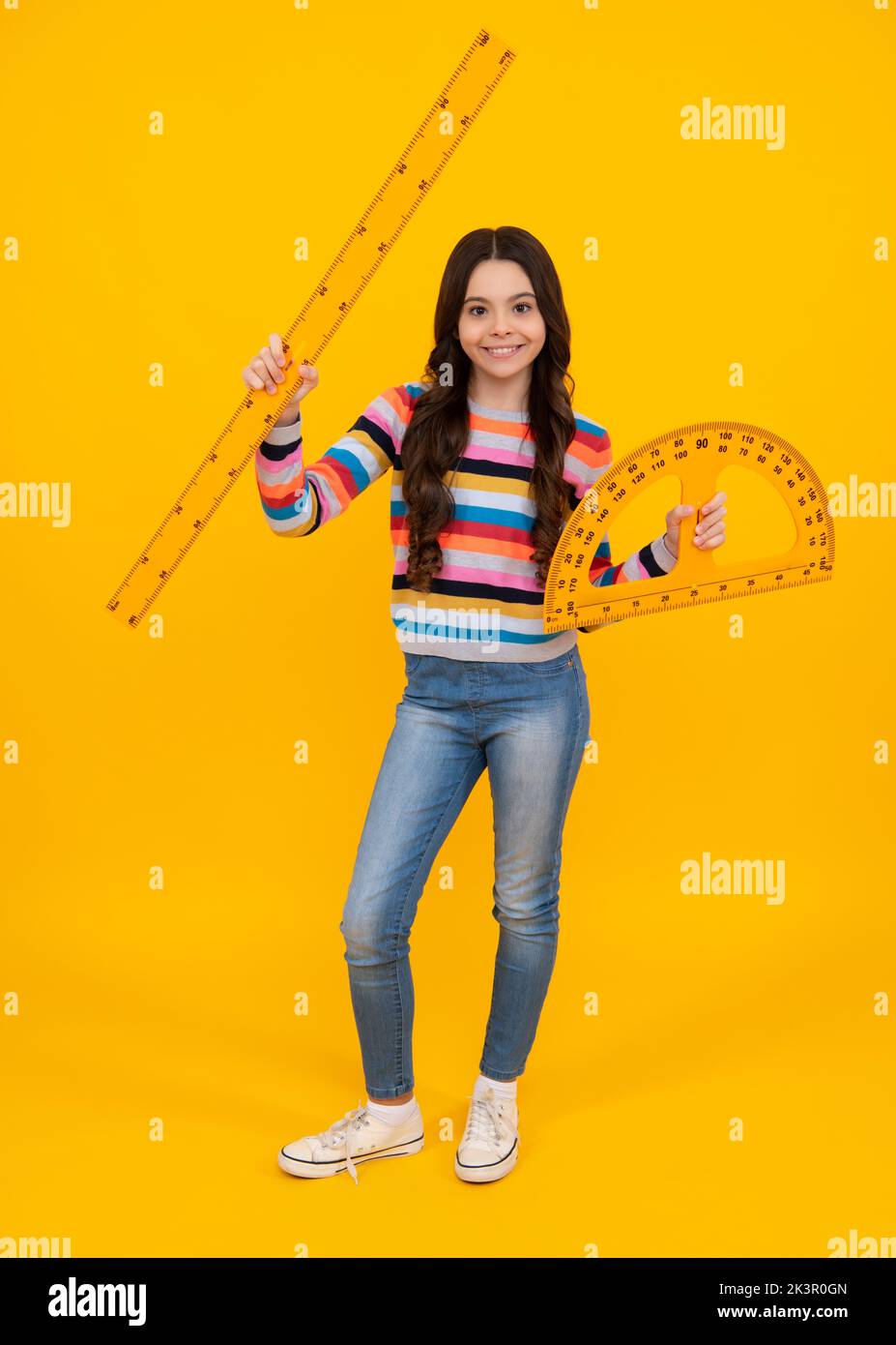 Schoolgirl in school uniform hold mathematics measure. Metric ...