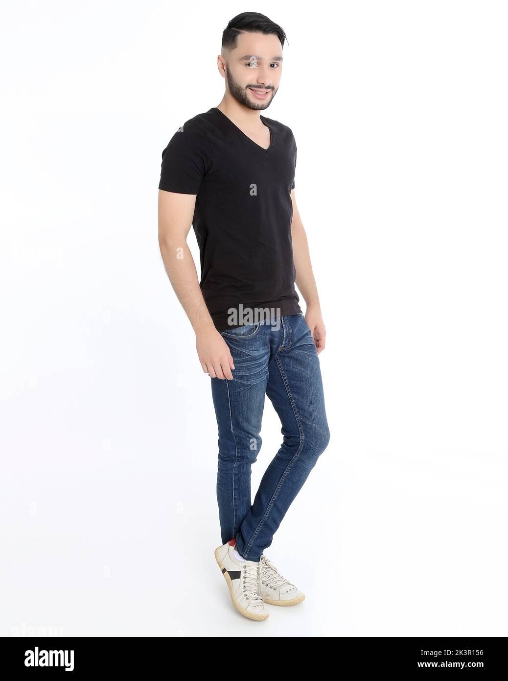A long shot of an attractive Caucasian male model posed smiling in a ...