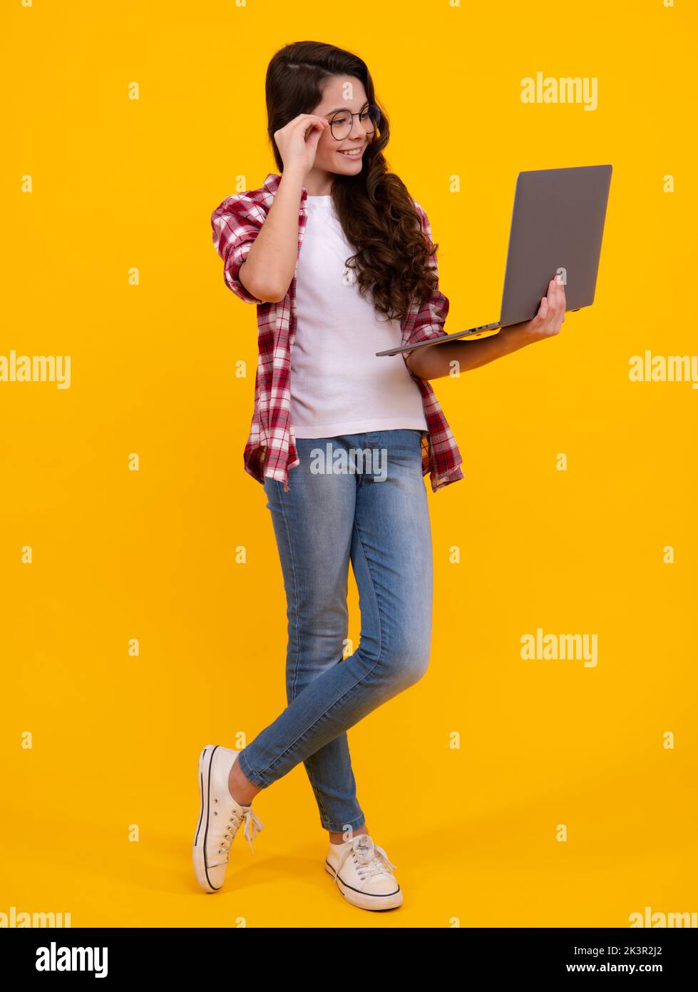 Teenager school girl hold notebook laptop. School children on isolated ...