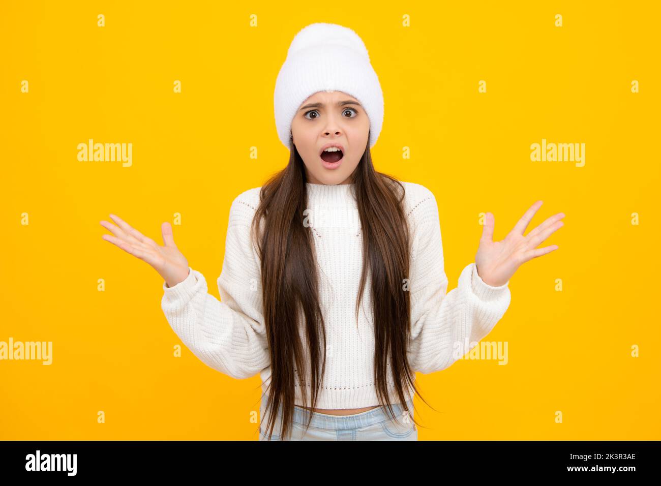 Angry teen girl. Child looking at camera with hate and rage negative facial expression. Unhappy ...