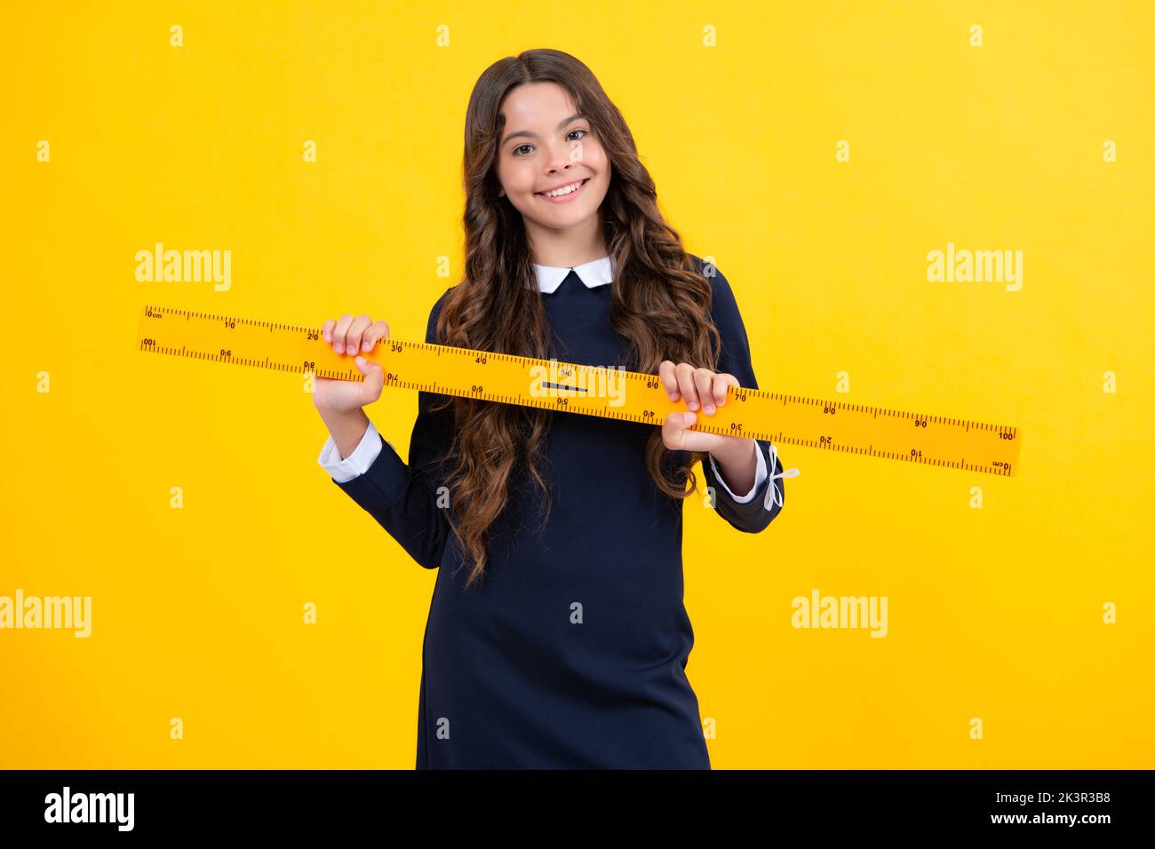 Measuring school equipment. Schoolgirl holding measure for geometry ...