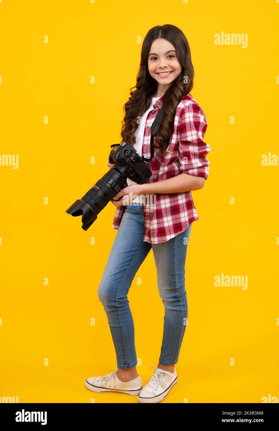 Teenager girl with dslr photo camera with zoom lens. Child photographer ...