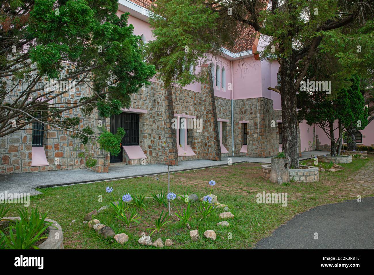Mai Anh Domaine De Marie Church garden with vintage windows on brick ...