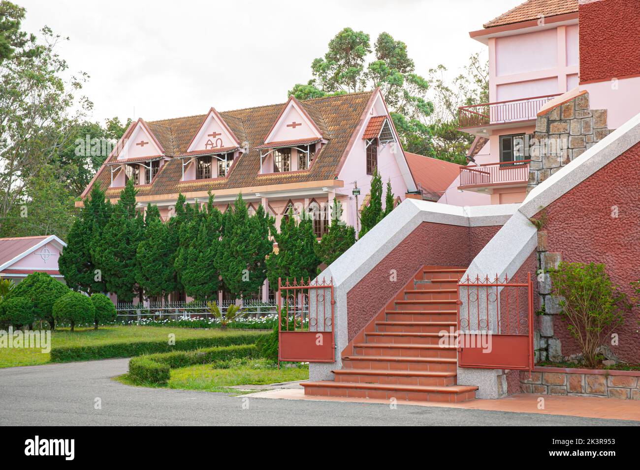 Mai Anh Domaine De Marie Church garden with vintage windows on brick ...