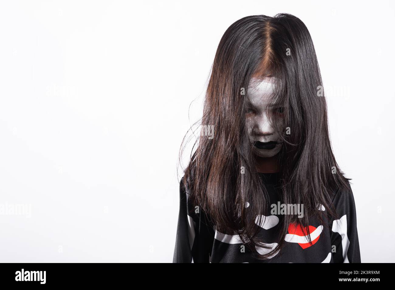 Asian little kid girl with face painting and hair covering face, woman ...