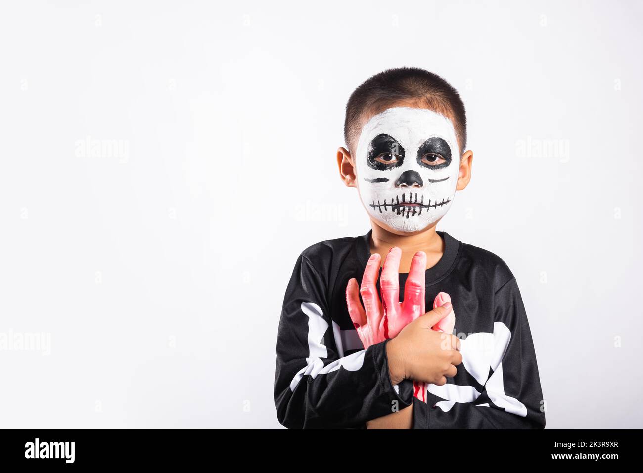 Halloween Kid. Portrait of Asian little kid boy wearing skeleton ...