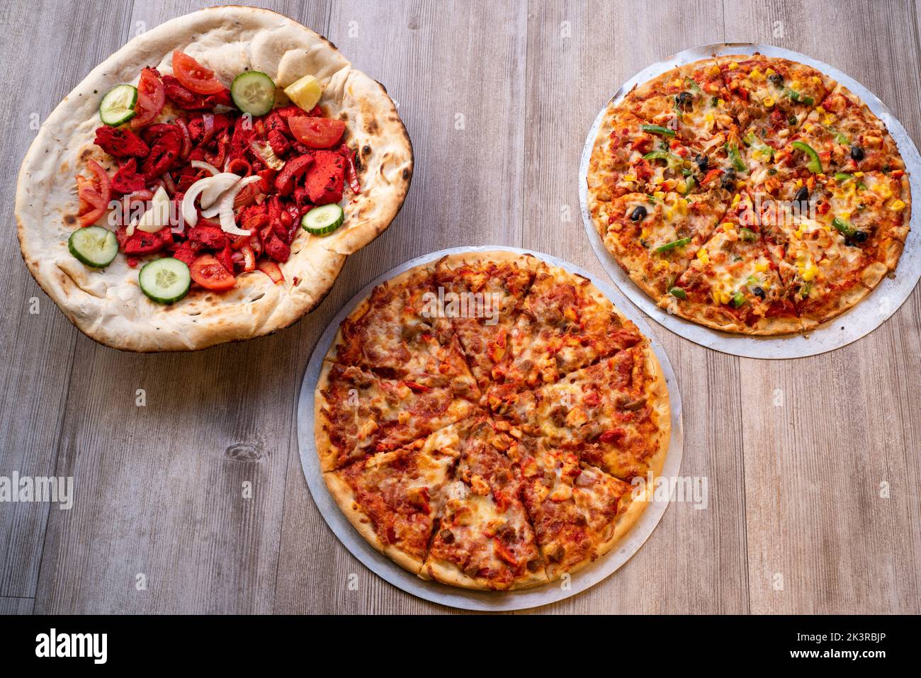 Delicious hand made pizzas and chicken tikka on naan from above Stock ...