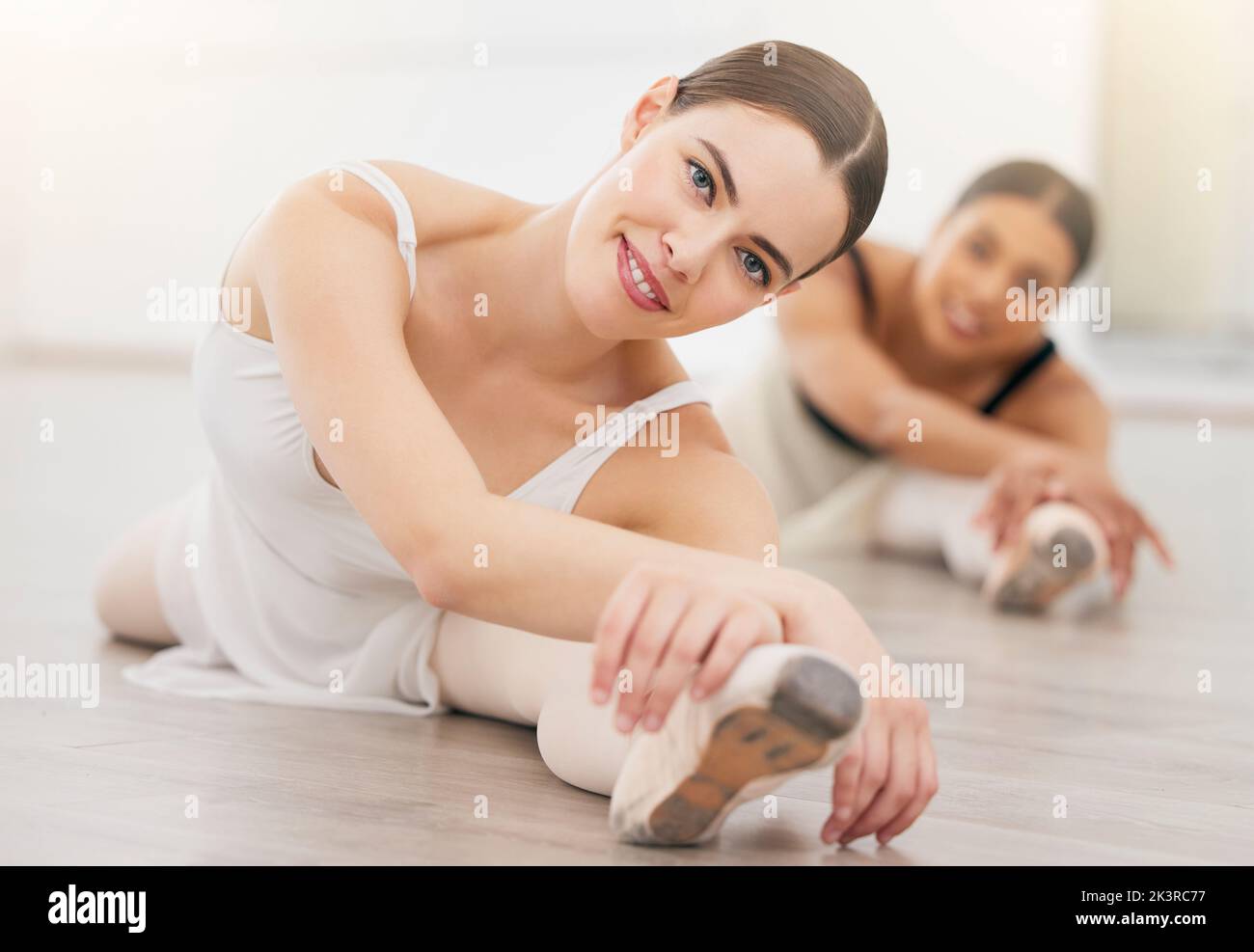 Ballet, flexible and dancer stretching in class to warm up before ...