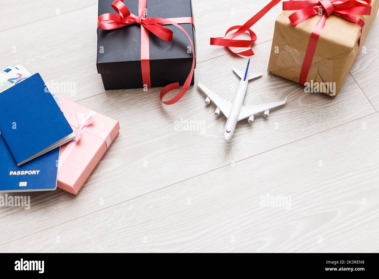 Christmas airplane travel concept. Passports, toy white plane. Gift box ...