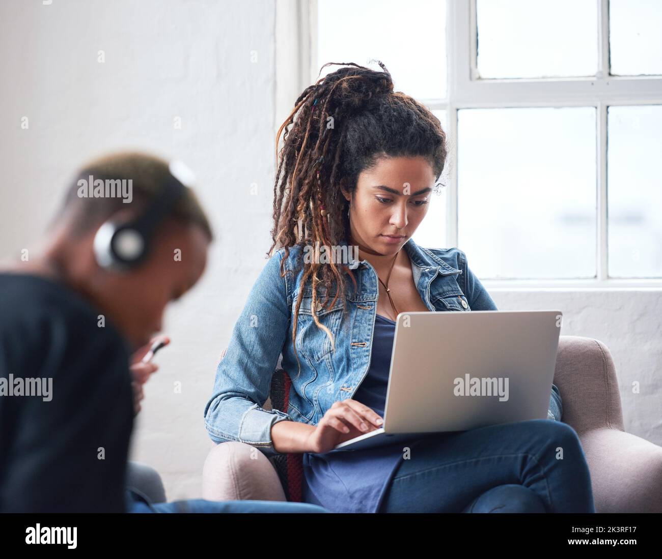 Black woman working on laptop computer in internet cafe or young female ...