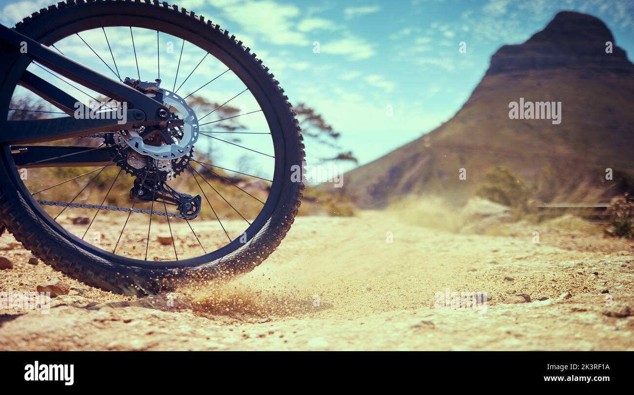 Bike, sport and adventure with a bicycle wheel in the dirt for ...