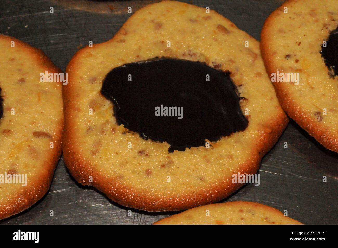 Almond cookies with a jam bath Stock Photo - Alamy