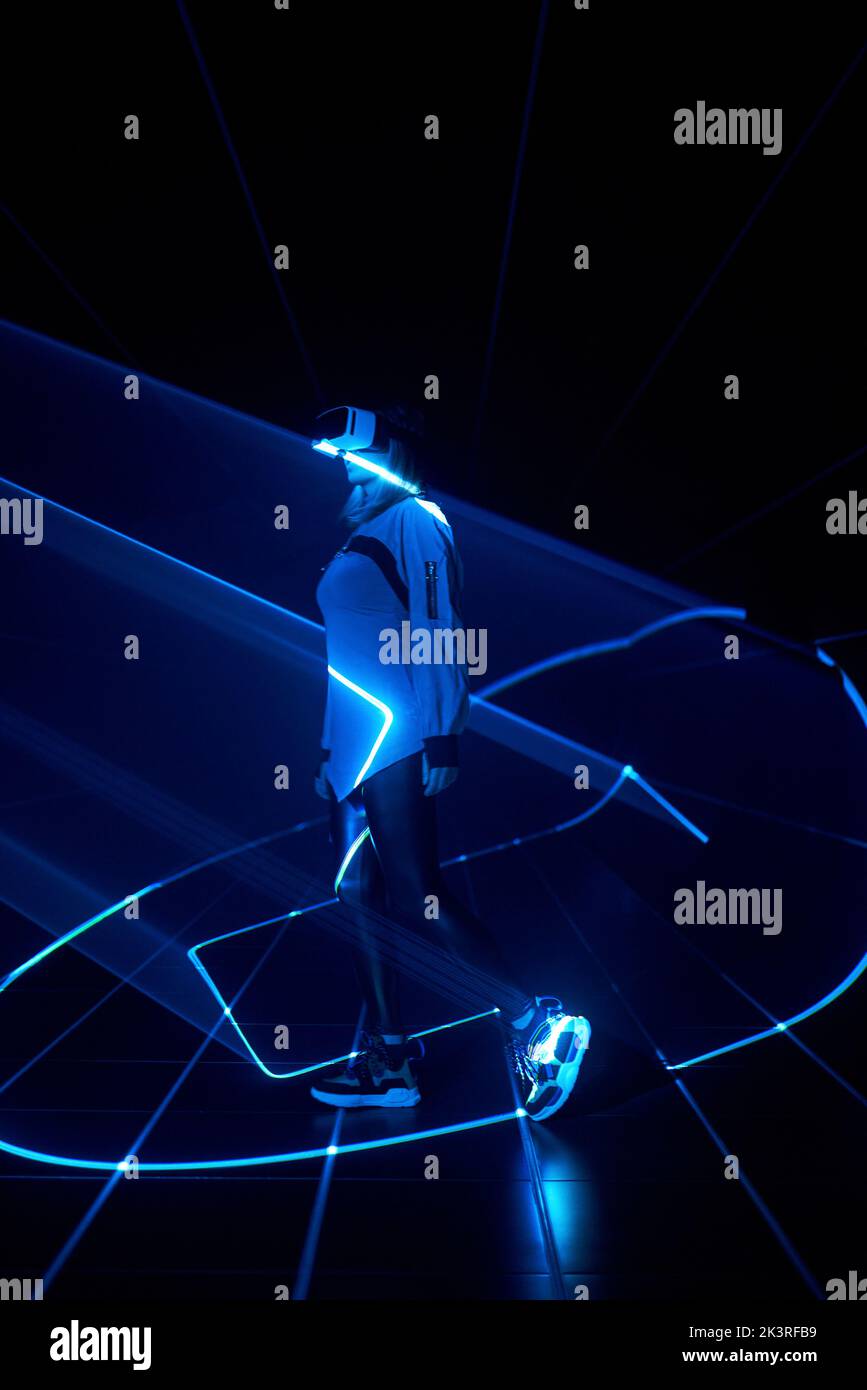 Woman is using virtual reality headset to access in metaverse. Concept ...