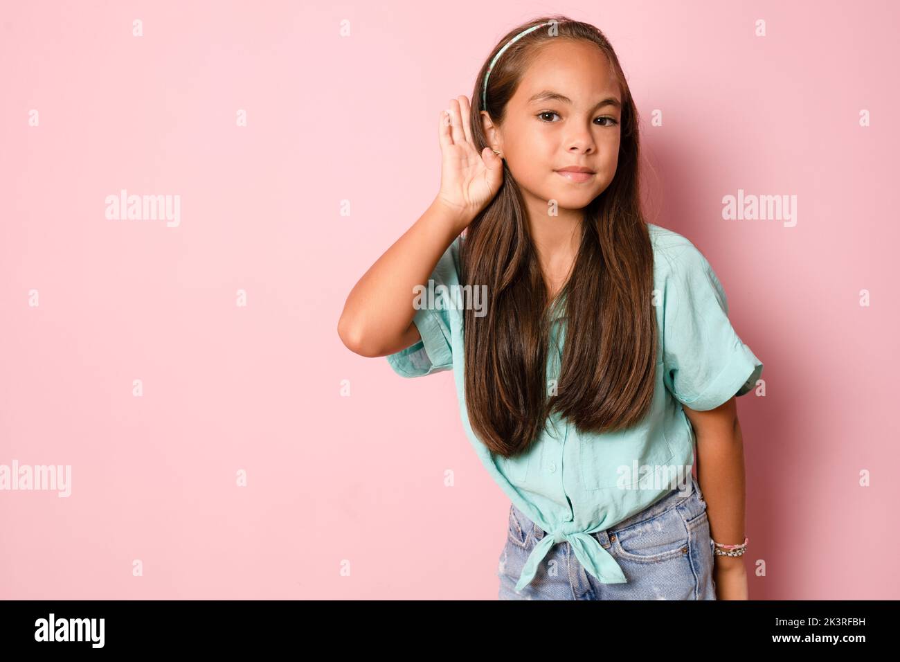Little girl trying to hear you overhear listening intently isolated on ...
