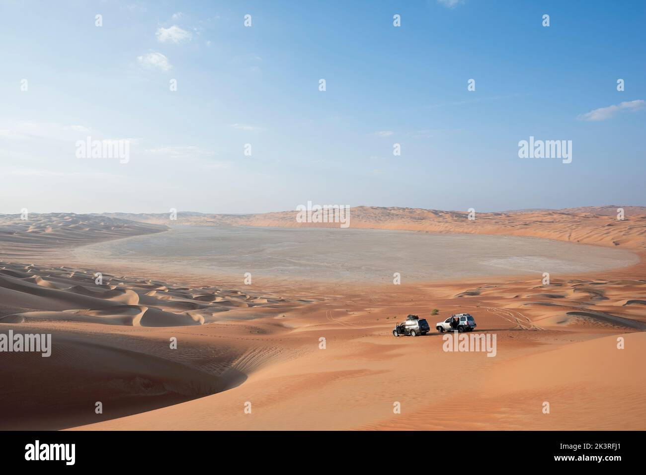 Off-road vehicles stopped in the dunes with a scenic view of a ...