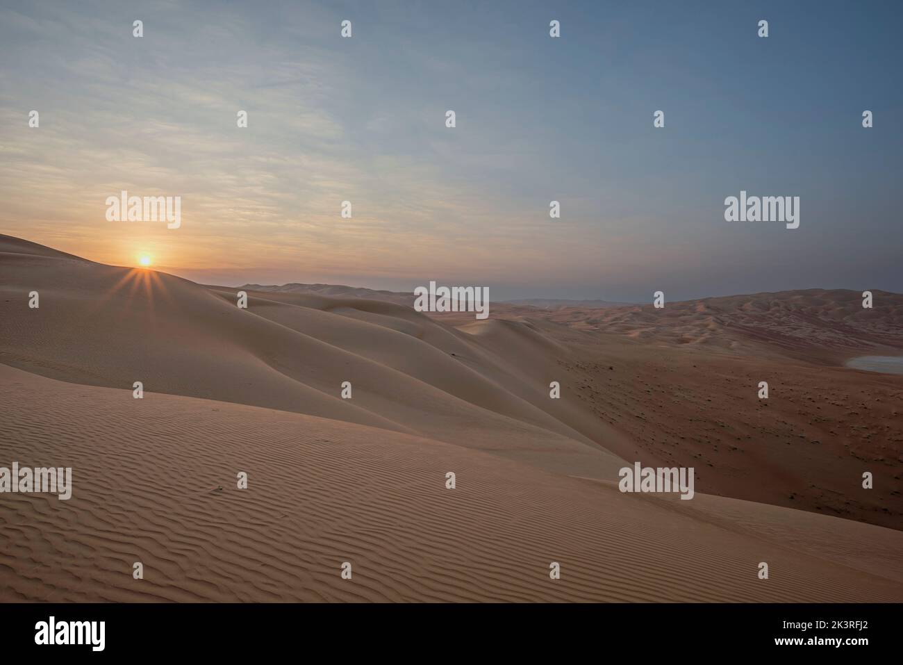 Sun rising behind dunes in the desert of the Middle East, Arabian ...