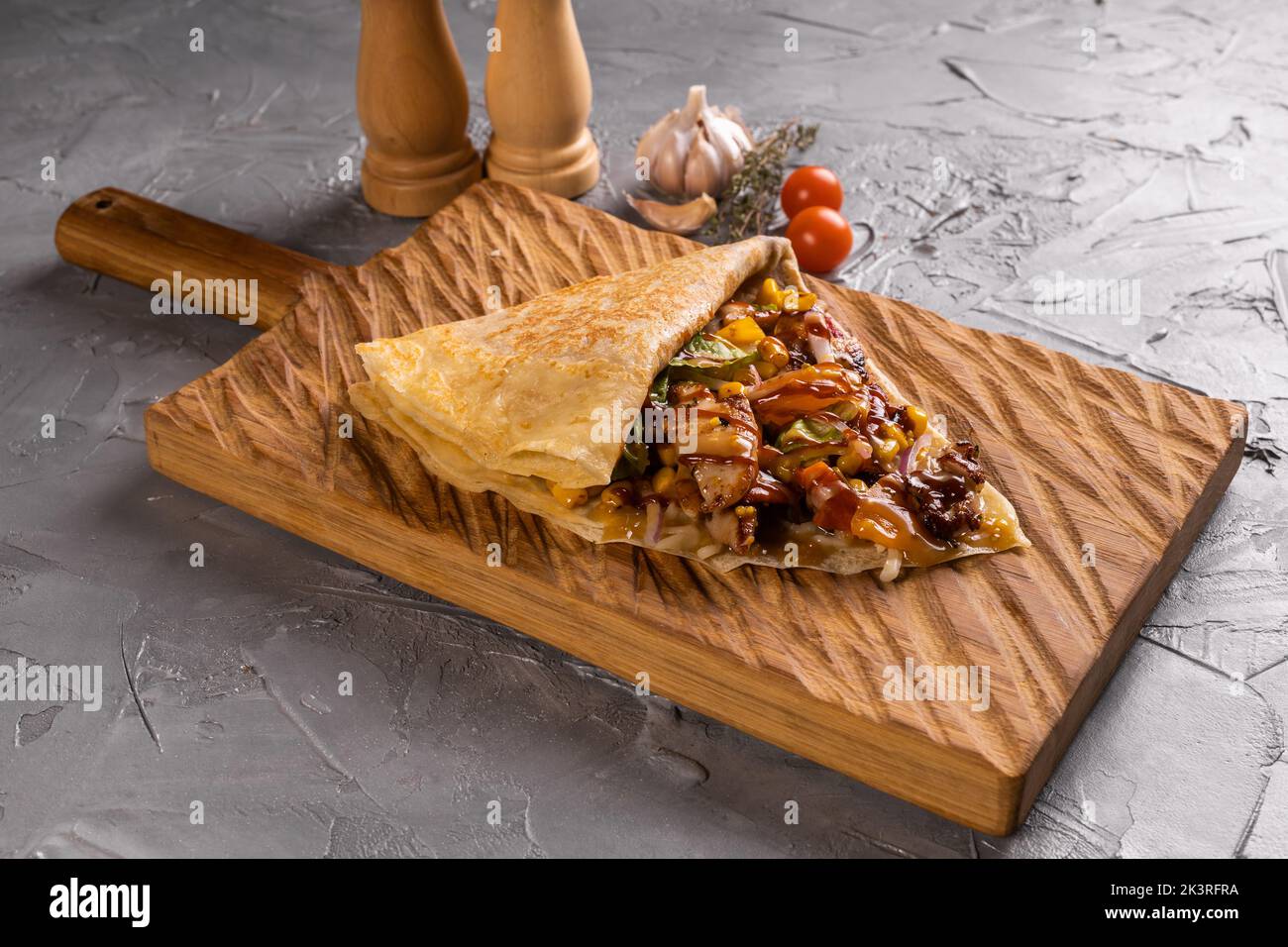 Delicious crepes pancake with vegetables, chicken, mushrooms on wooden ...