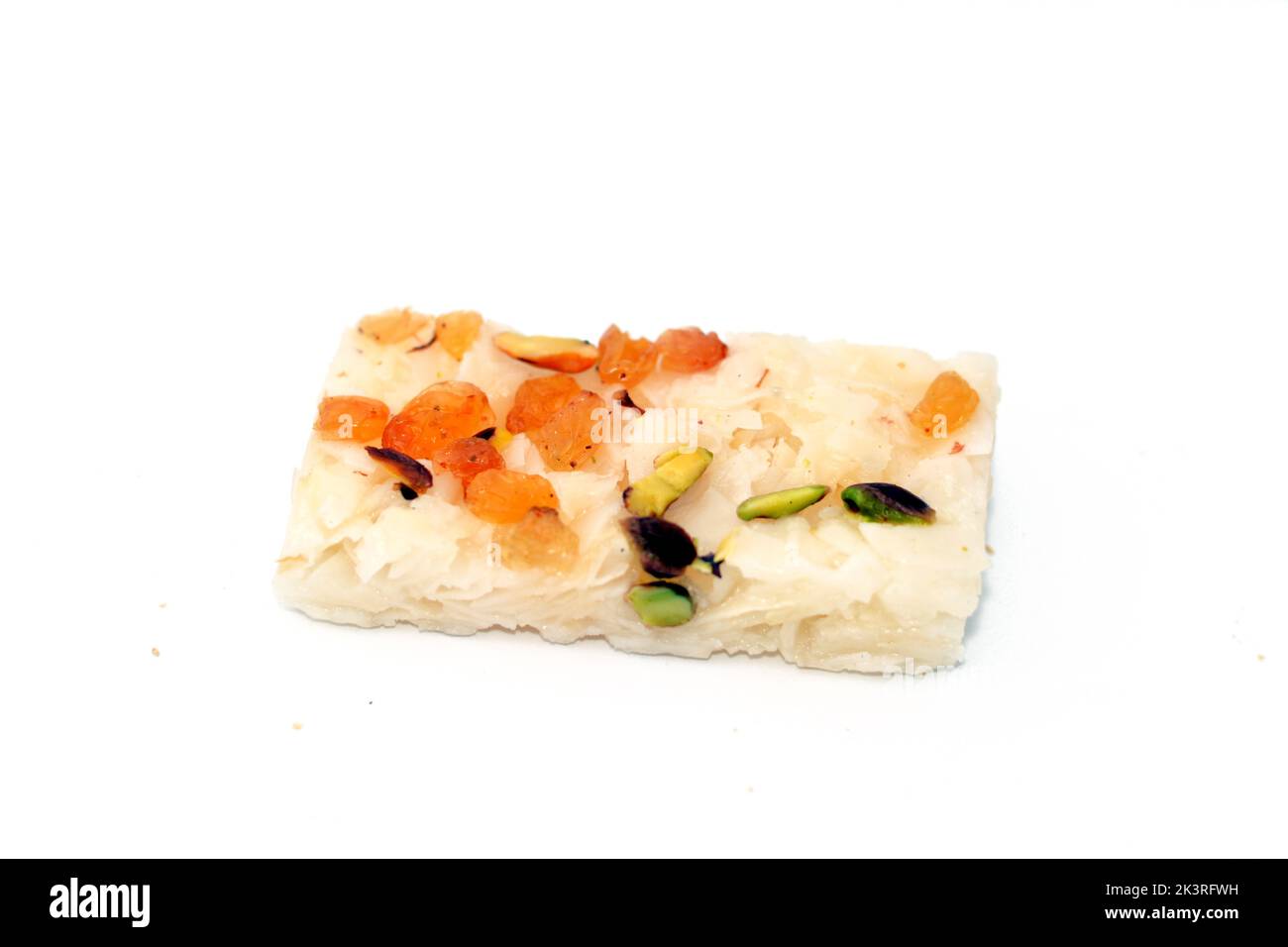 Coconut with raisins and pistachio nut, an Eastern candy made as a ...