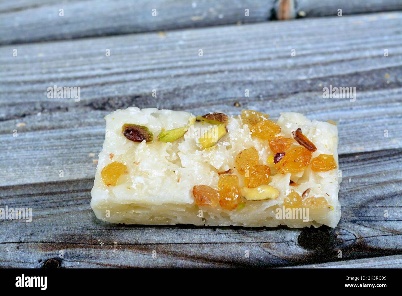 Coconut with raisins and pistachio nut, an Eastern candy made as a ...