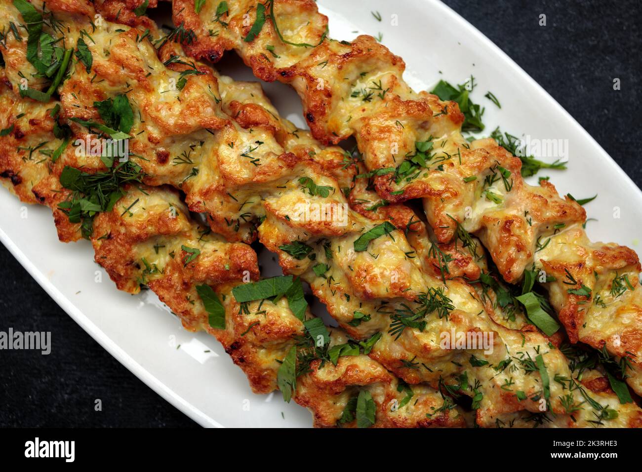 Chicken lulia kebab with herbs on a plate, on dark concrete Stock Photo ...