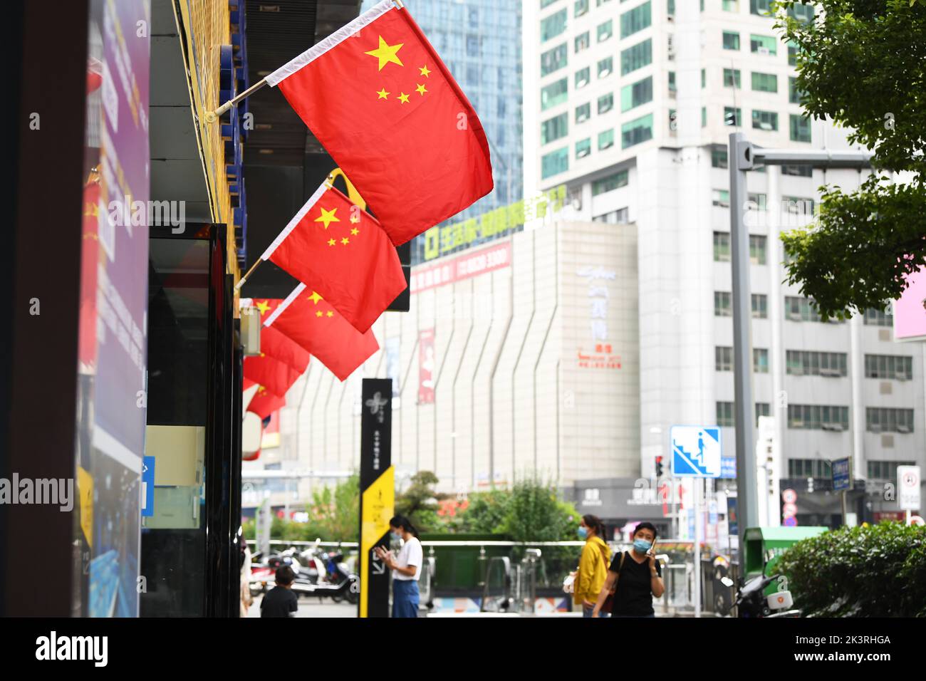 GUIYANG, CHINA - SEPTEMBER 28, 2022 - People pass a street under a ...
