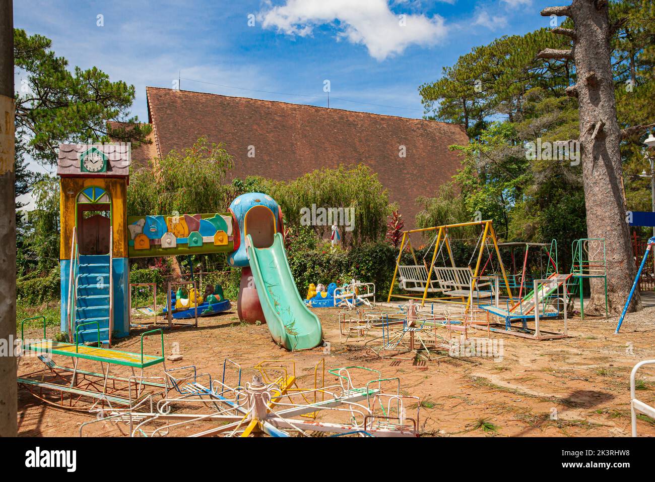 Old abandoned colorful playground in backyard with slide stands, swing ...