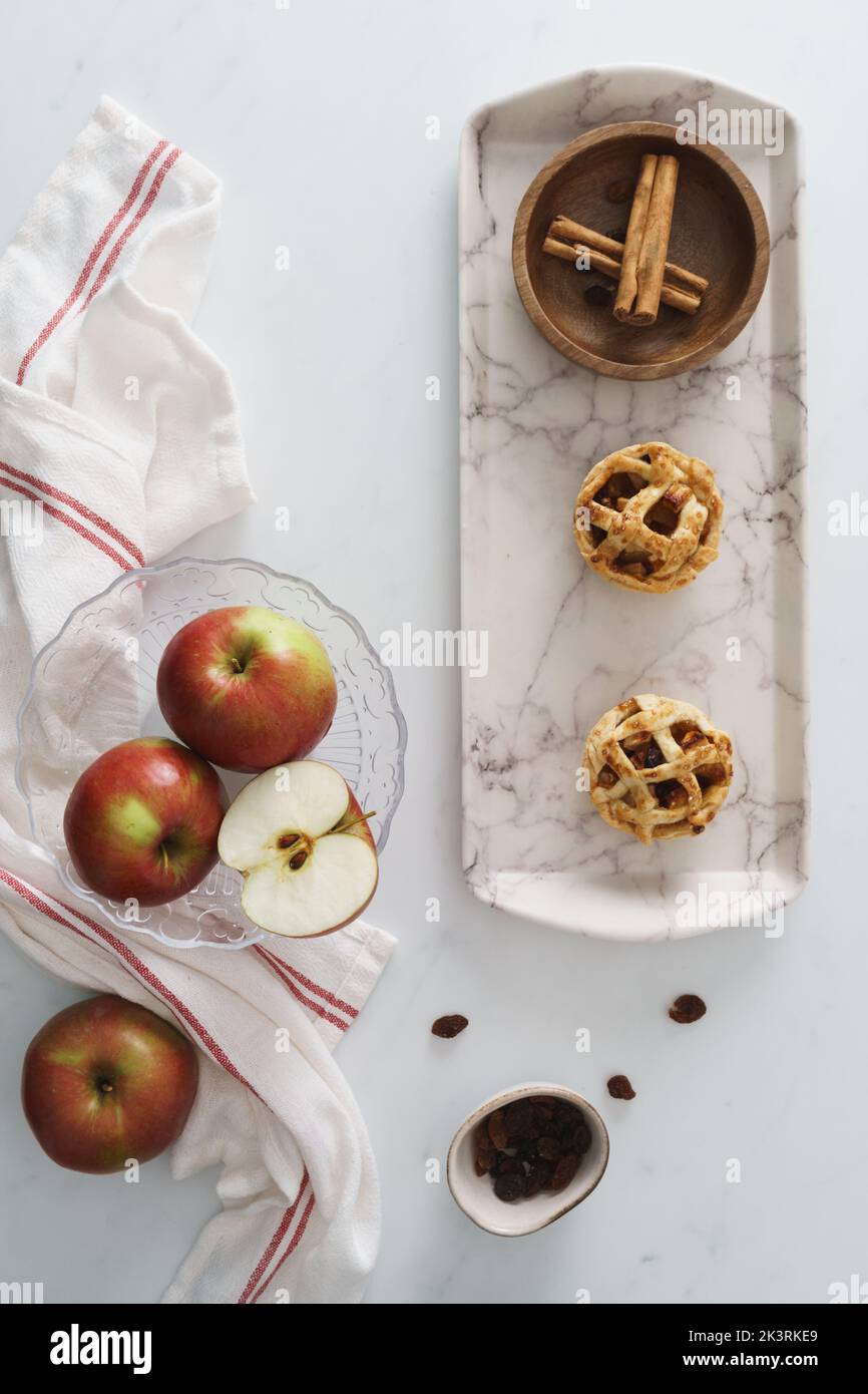 Apple and cinnamon mini pie tarts on white background. Food image with ...