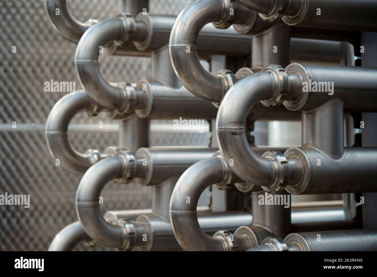 Close up shot of many alloy inox pipes in a factory Stock Photo - Alamy