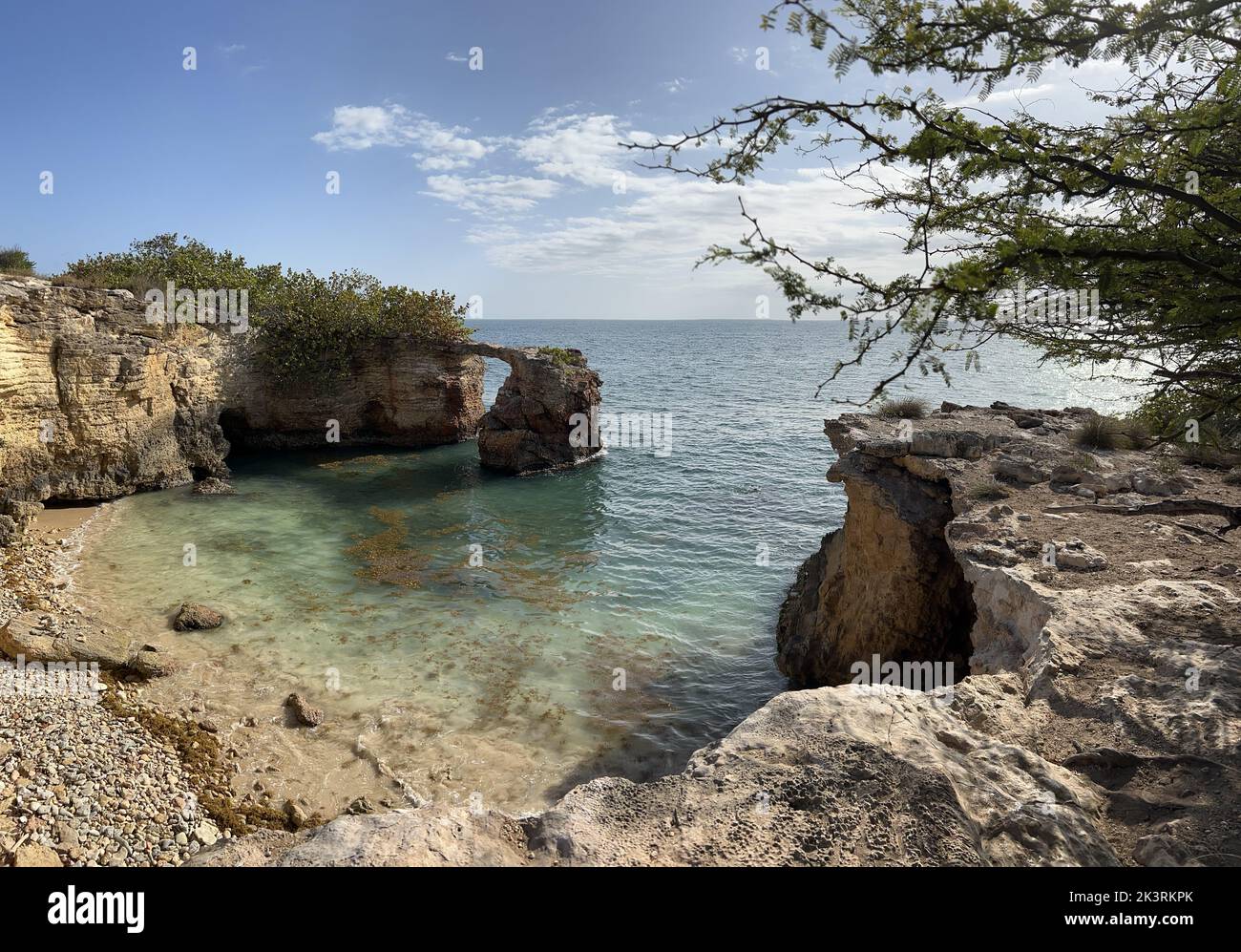 A Rock bridge over the sea on a sunny day Stock Photo - Alamy