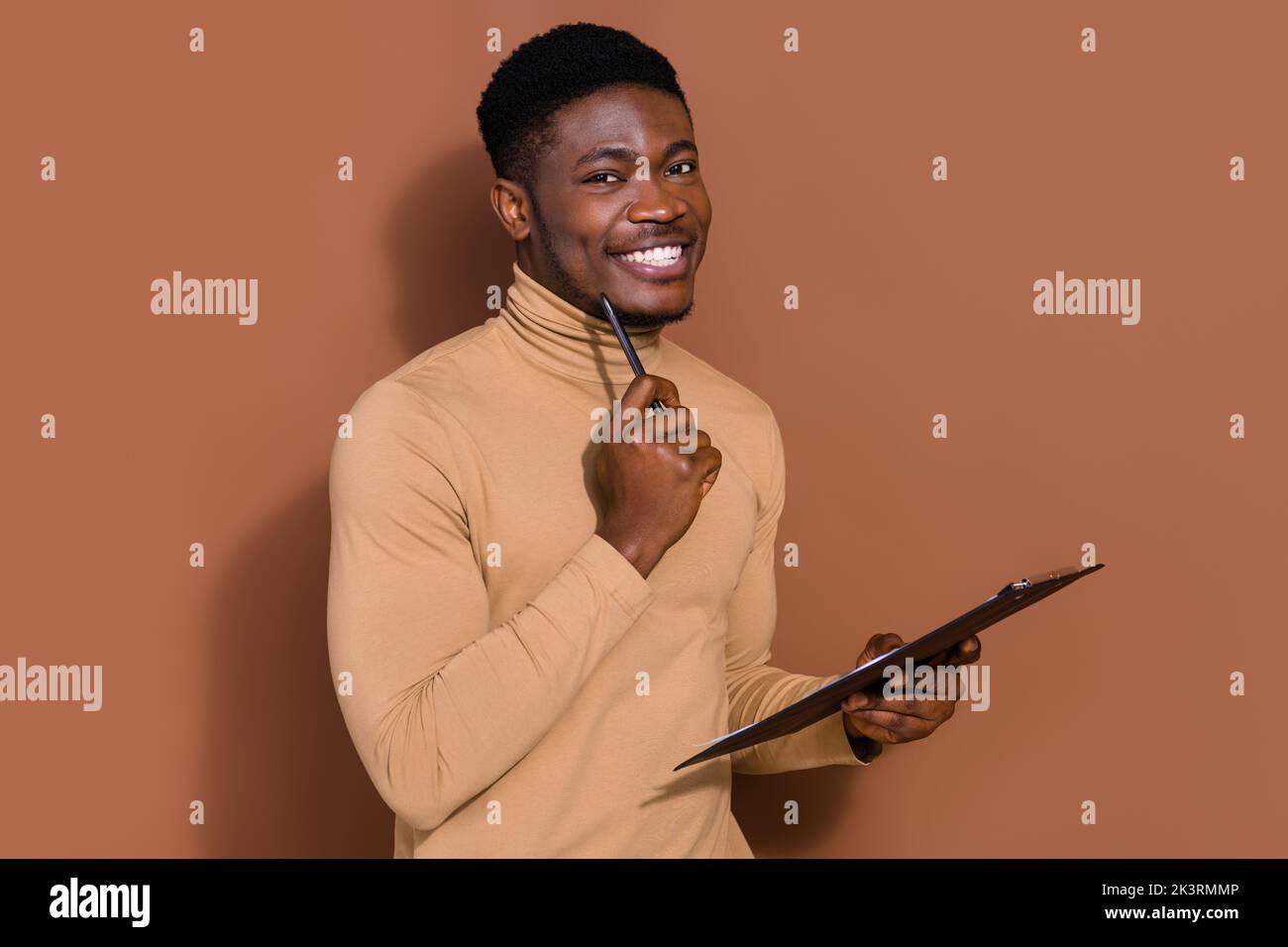 Portrait of attractive trendy cheerful guy filling application form ...