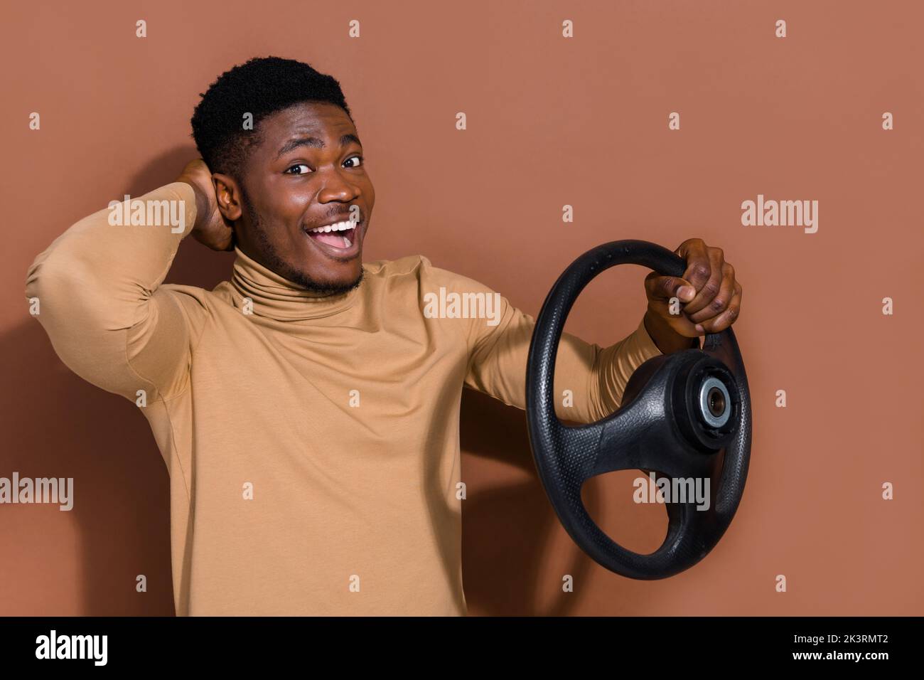 Photo of cute millennial brunet guy drive auto wear beige shirt ...