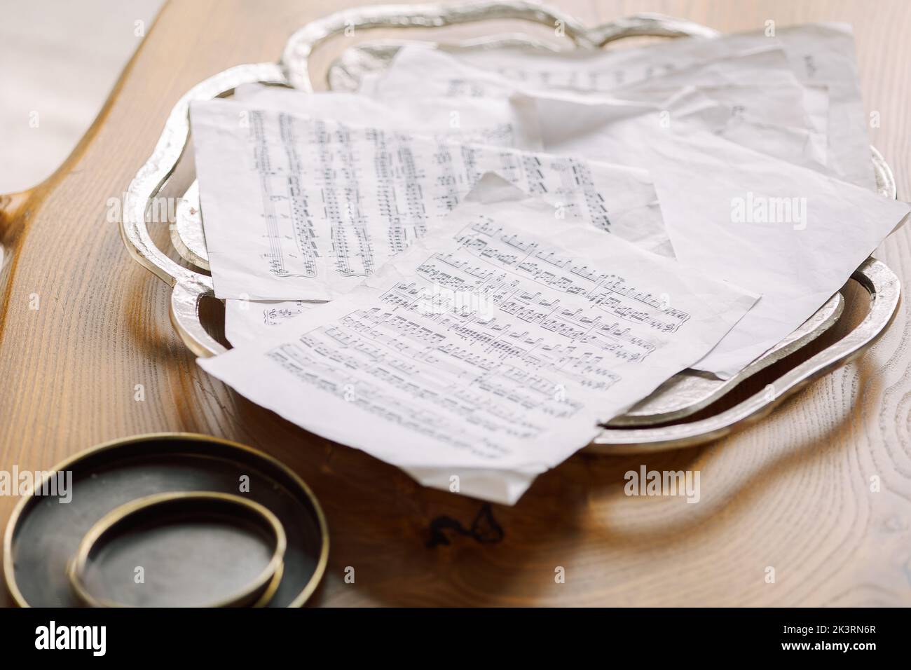 Music notes pages scattered on wooden table Stock Photo - Alamy