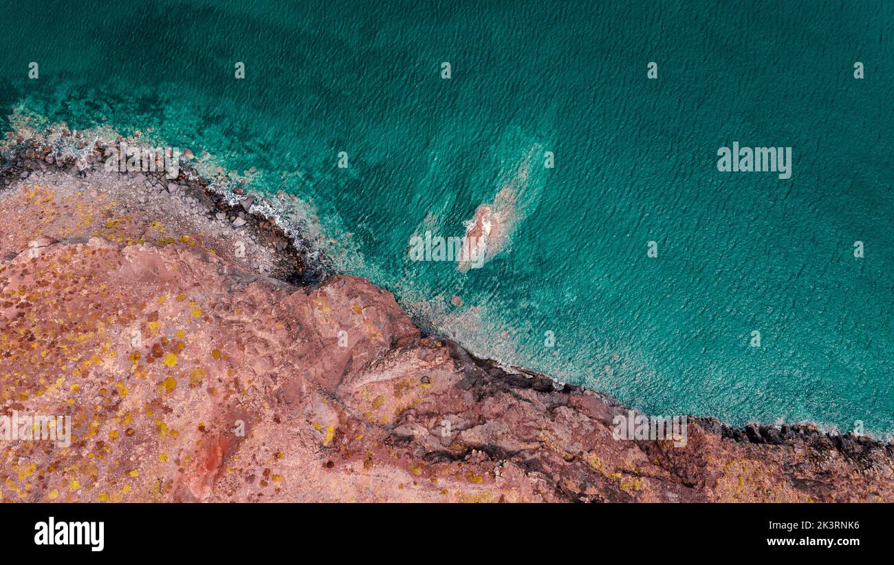 Atlantic ocean coastline with red cliffs, rocks, turquoise waves and ...