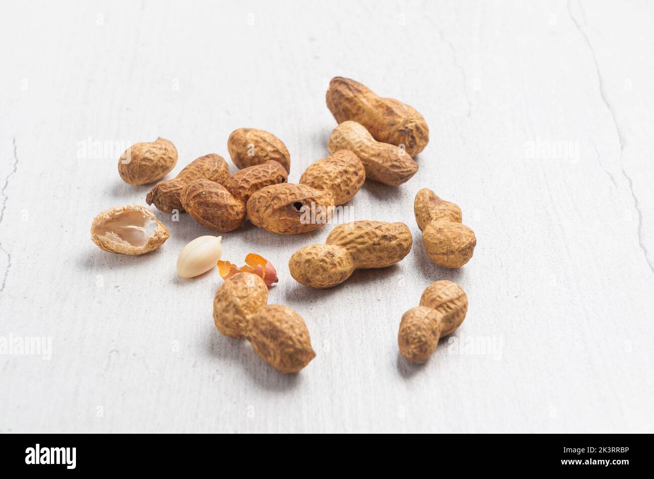 tasty peanuts in a shell on a light background Stock Photo - Alamy