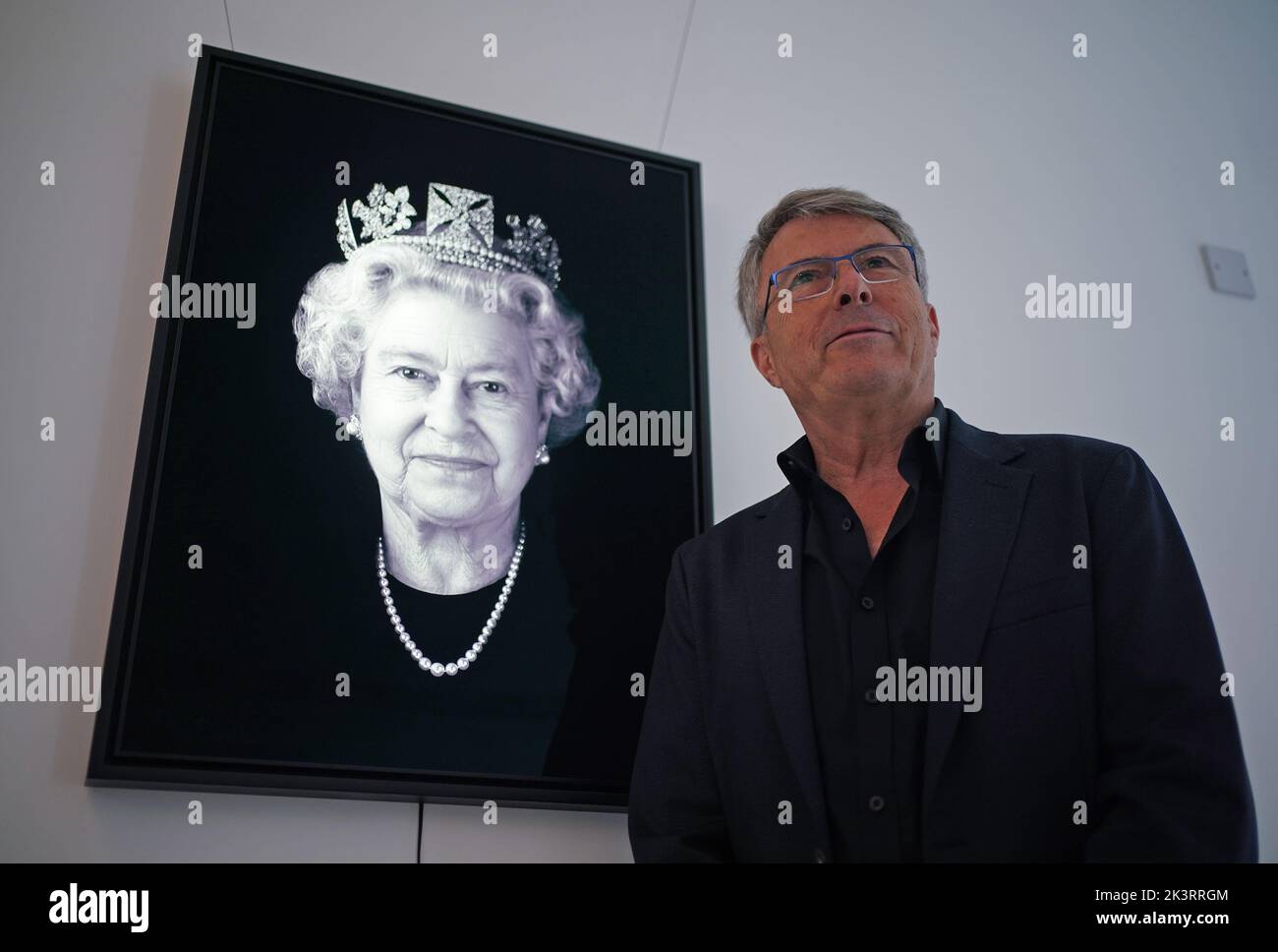 Rob Munday poses next to his work Platinum Queen: Felicity, 2004 ...