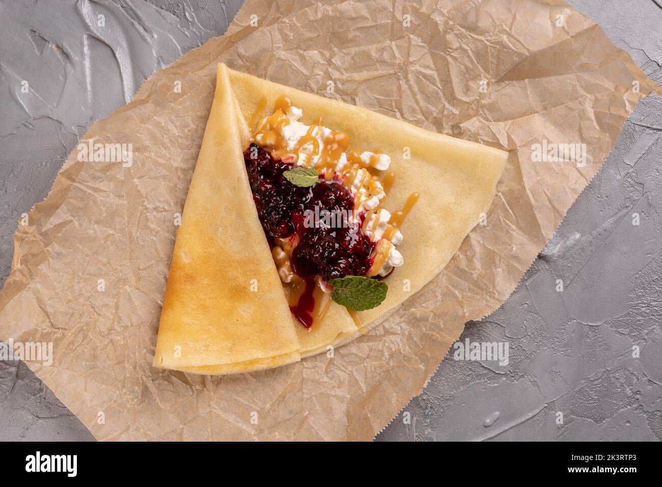 Pancake or crepe with cottage cheese and berry sauce Stock Photo - Alamy