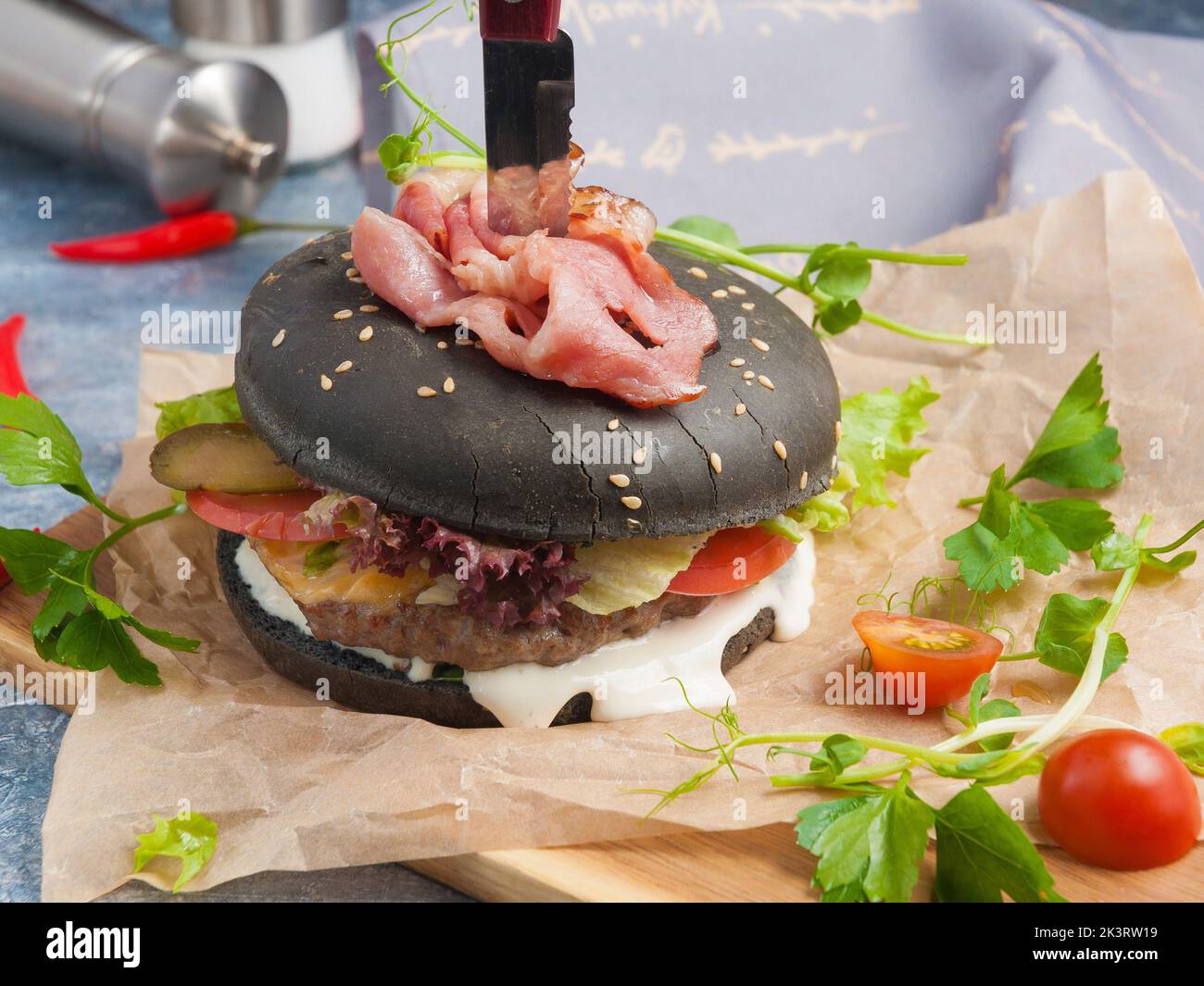 tasty black Burger with beef, bacon, cheese and vegetables Stock Photo ...