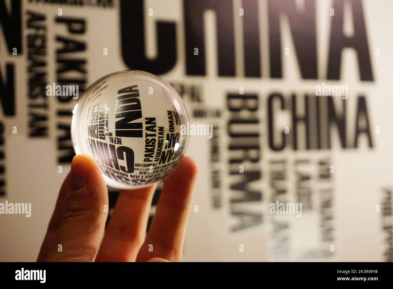 A glass sphere with reverse reflection in a hand Stock Photo - Alamy
