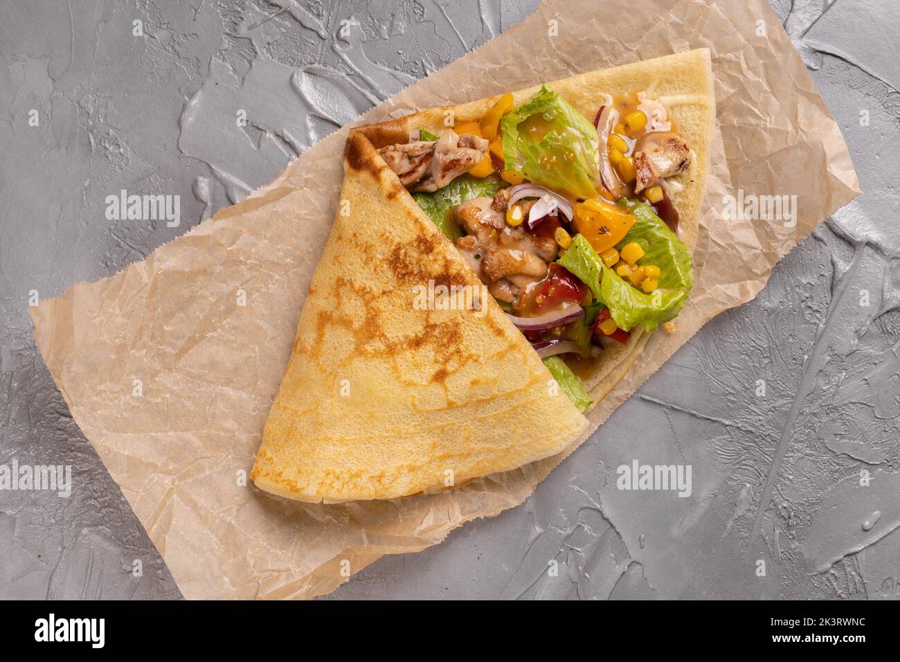 Delicious crepes pancake with vegetables, chicken, mushrooms. Top view ...