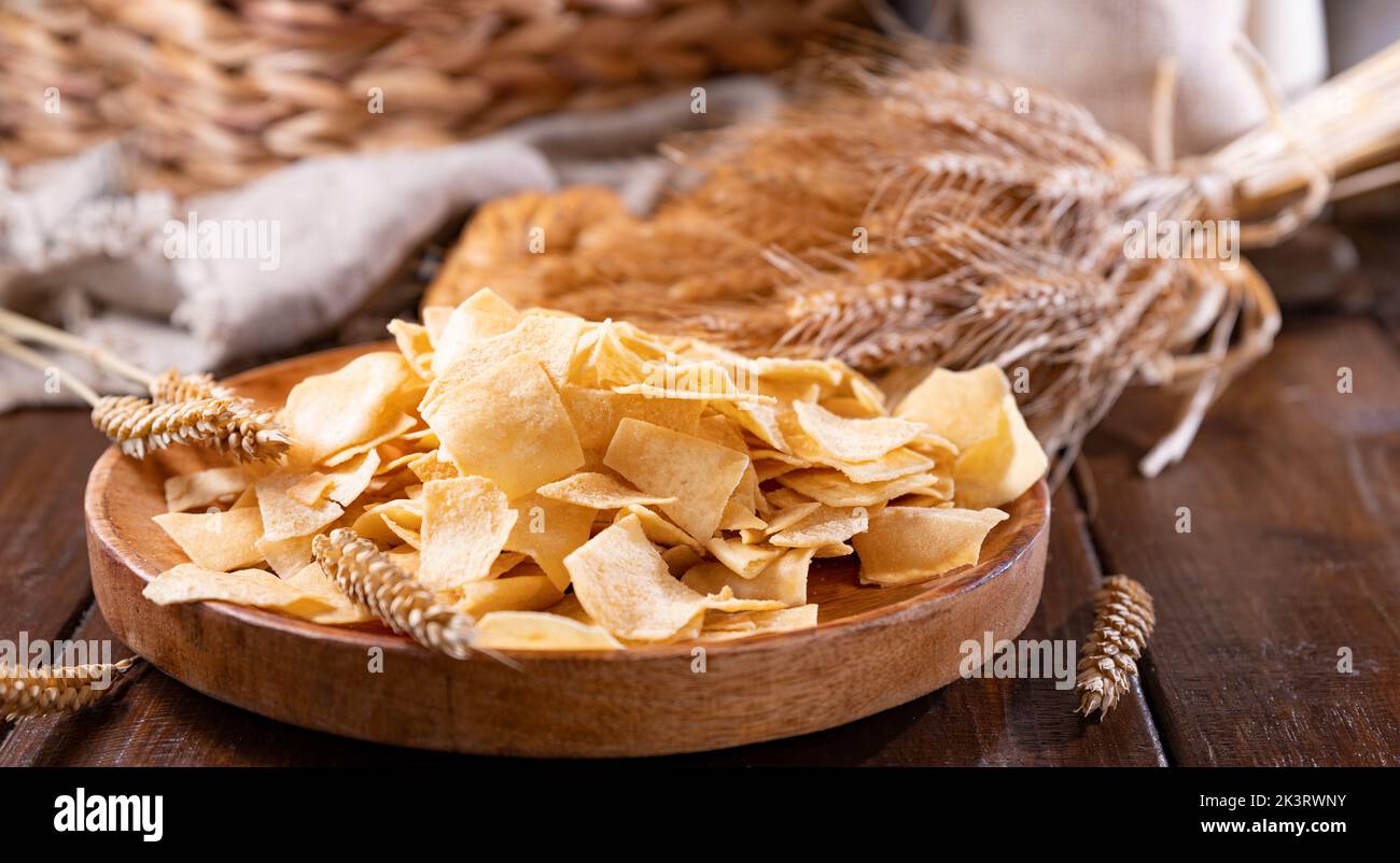 Bread chips, a typical appetizer for aperitivo, dinner in southern Italy and Sardinia. Thin ...