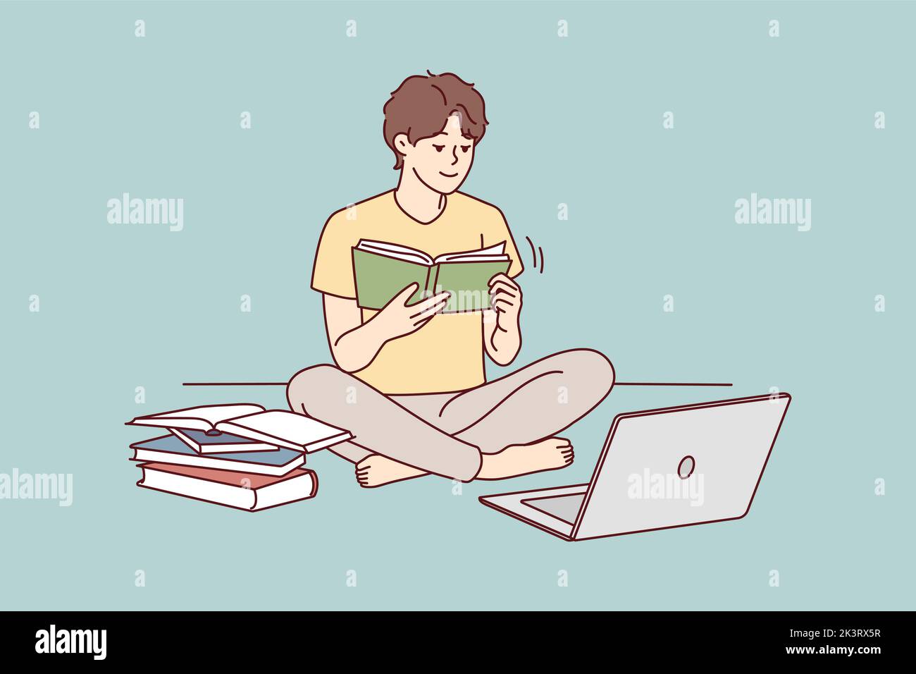 Guy sit on floor study on compute read textbooks prepare for exam ...